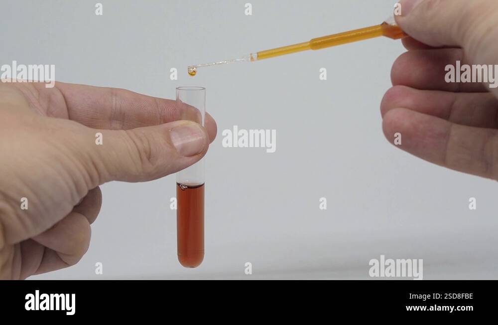 Liquid drops dropped from a medical dropper. Laboratory mixing fluids ...
