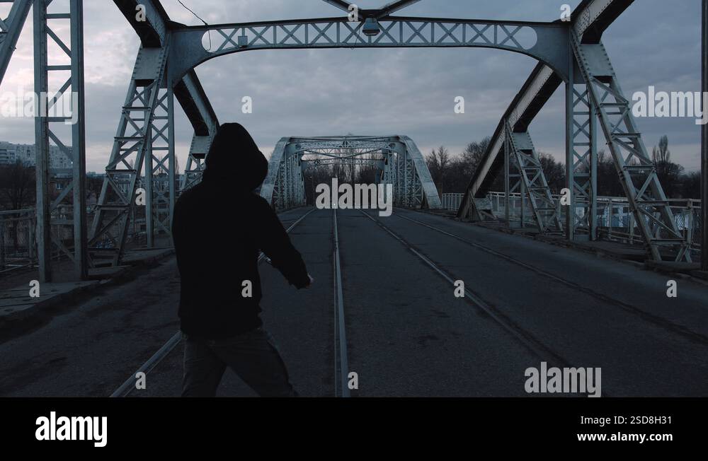 Young man in hoodie and balaclava with red burning signal flare on the ...
