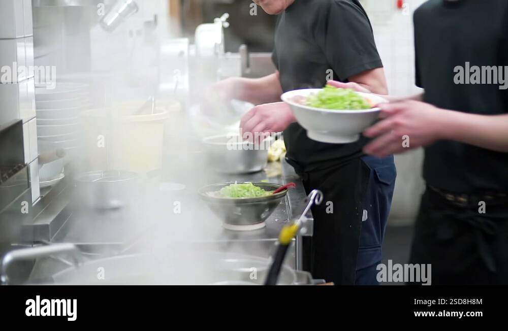 Kyoto, Japan - Two Japanese Chefs cooking Ramen in Kitchen of a Ramen ...