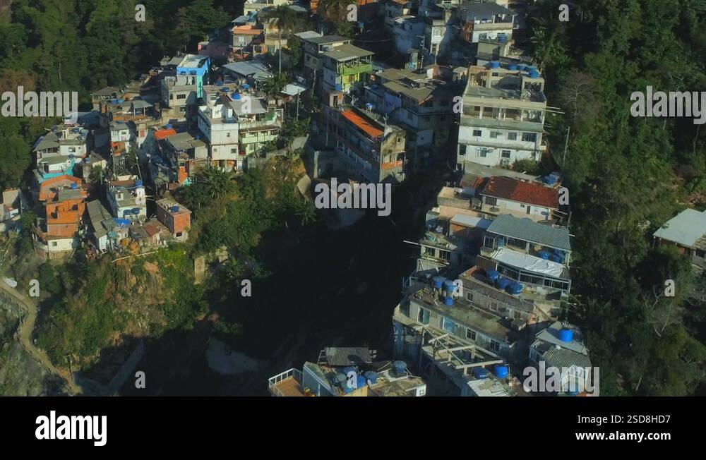 Close aerial approaching favela houses on mountain top surrounded by ...