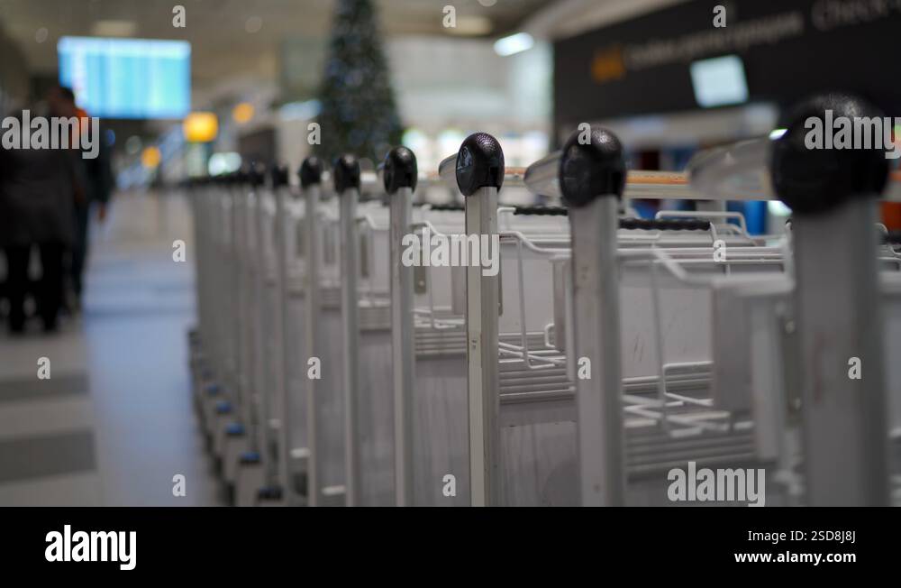 Row of luggage carts at airport terminal, airport baggage trolley ...