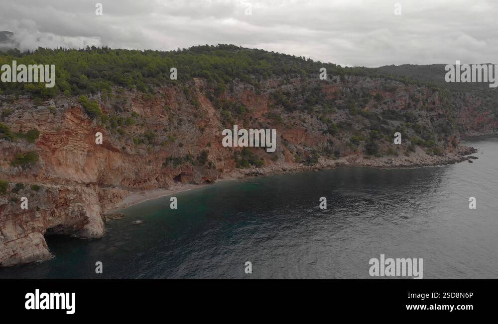 Steep cliff eith trail in tis slope and forest on top of plateau ...