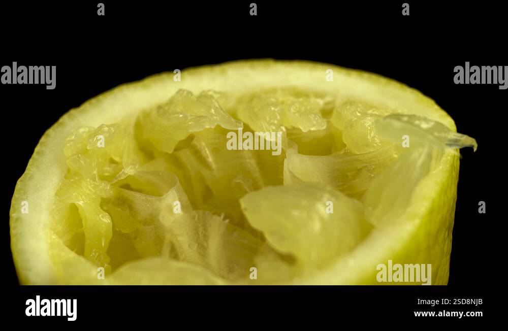 close up footage of squeezed lemon with black background. We drank the ...