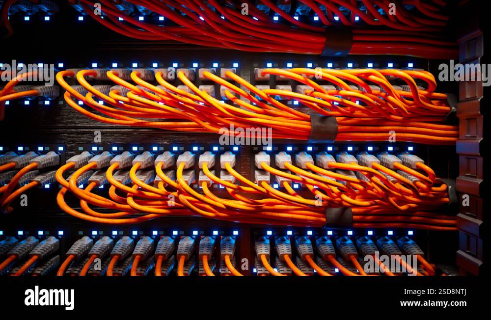 Countless orange cables in a server cabinet lit by a single spotlight ...