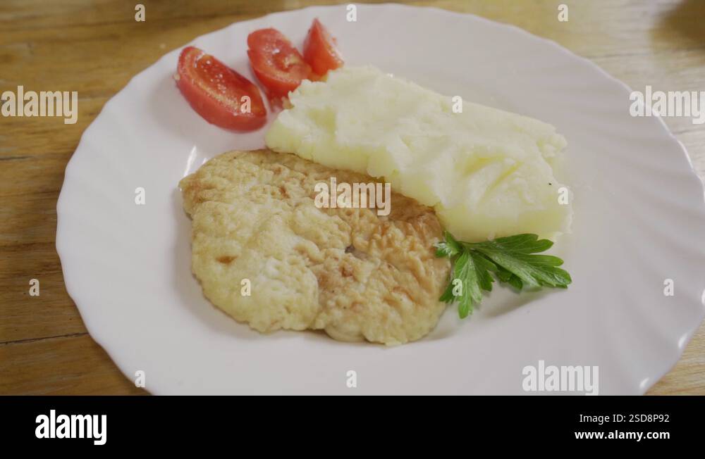 Someone eats mashed potatoes with chop and fresh vegetables in first ...