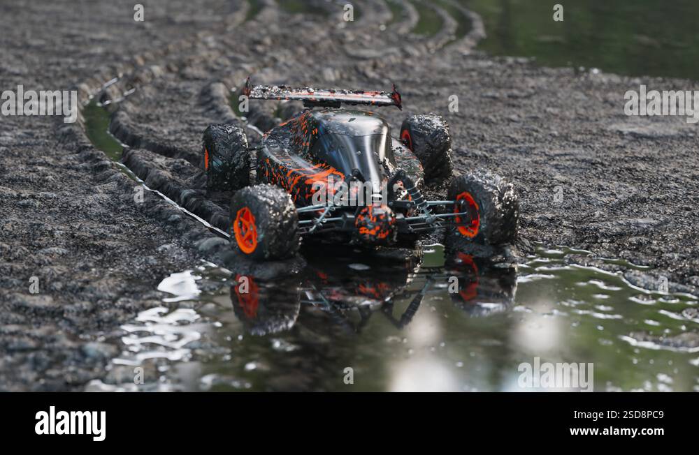 Dirty, orange RC-Car got stuck in the mud on a wet forest mire path ...