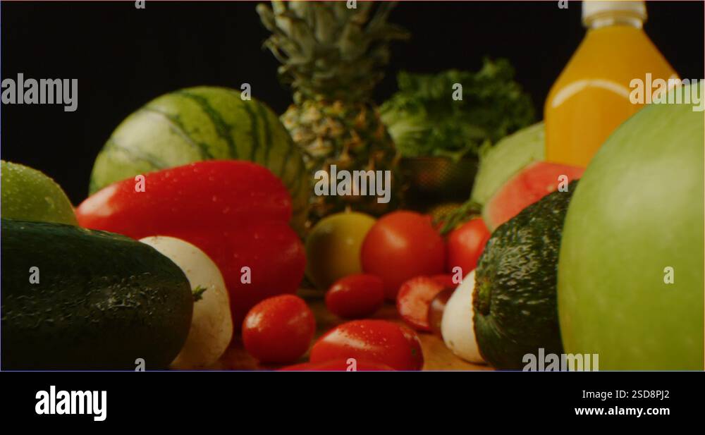 Pushing through composition of fruits and vegetables, sliding over ...