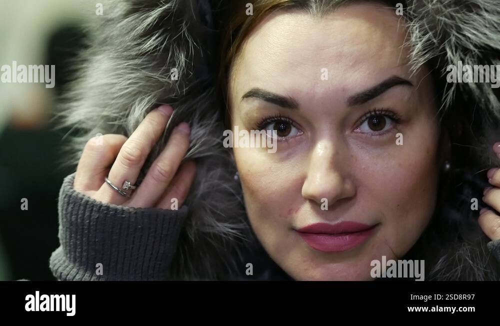 Young pretty lady perceptively looks at viewer while travelling on ...