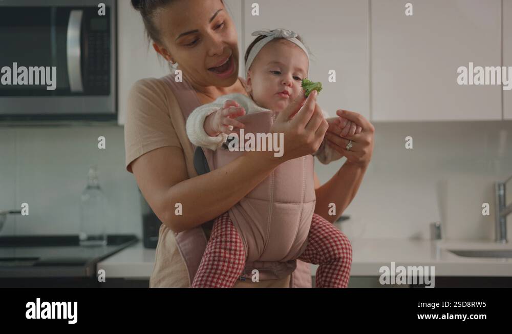 Young mother cook dinner with her little daughter, maternity leave ...