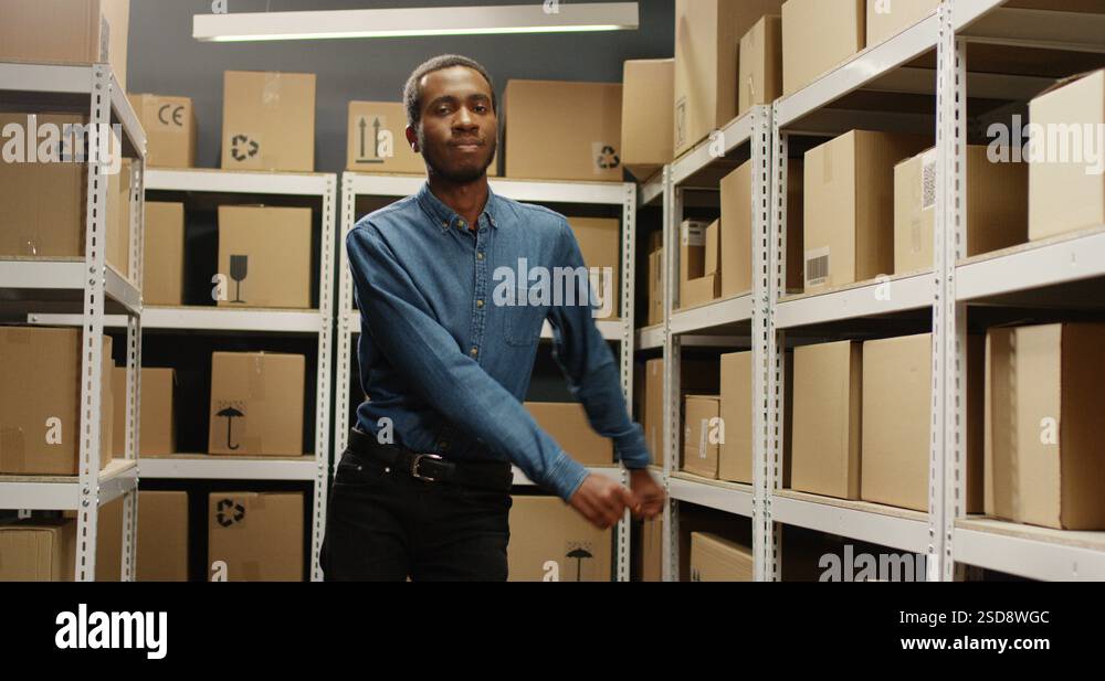 African American young cheerful male post office worker dancing in ...