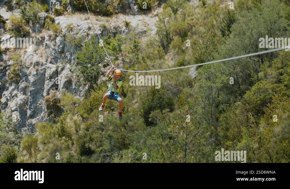 Zip line in mountains, a cable between rocks. Moving with zipline at ...