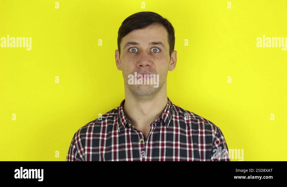 A funny, handsome guy expresses his fear and waves his hands away from ...