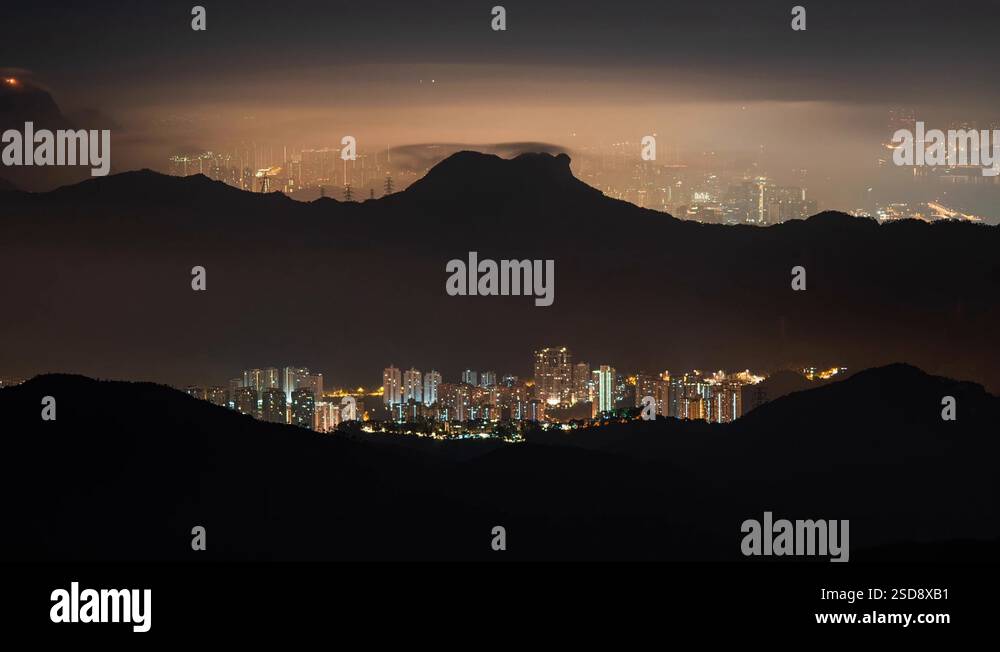 Shining city with colorful lights of buildings behind silhouettes of ...