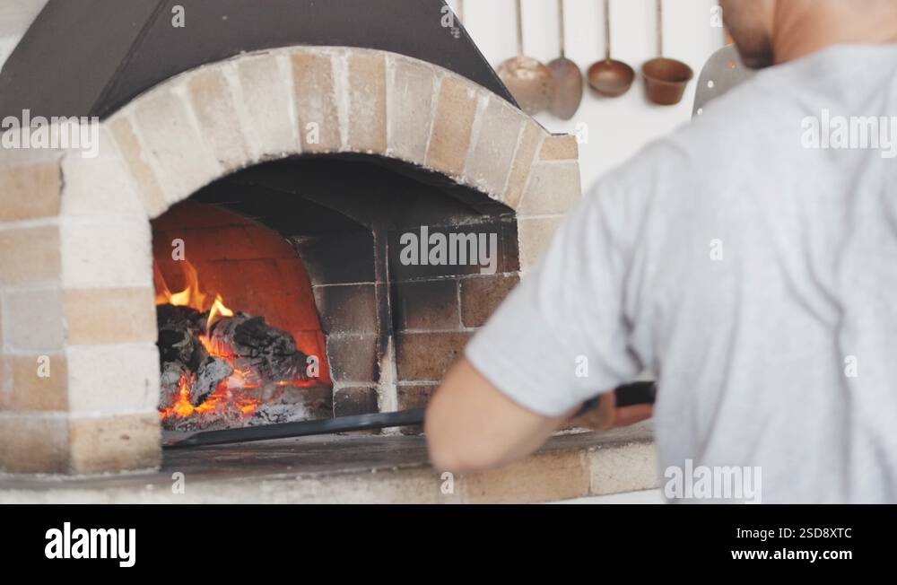 Pizzeria Master Making a real Italian pizza, Checks pizza for readiness ...