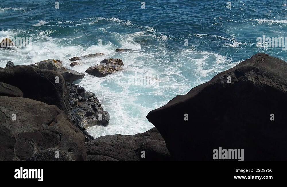 HD Slow motion Hawaii Kauai static looking down to ocean waves swirling ...