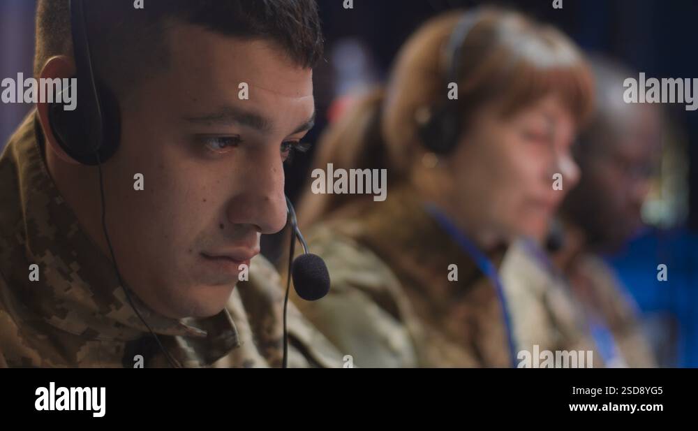 Close up of Caucasian male soldier in headset working as dispatcher in ...