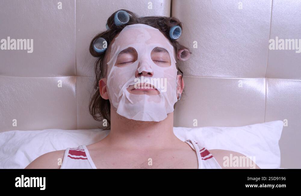 man with a cosmetic mask on his face, abruptly opens his eyes in dismay ...