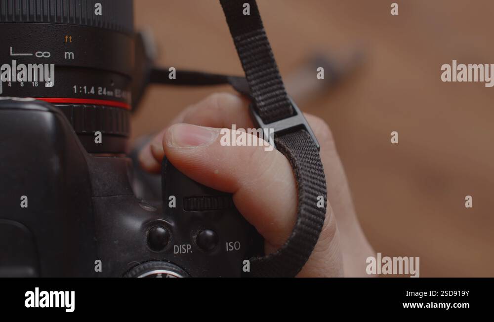 Top view of a part of the camera. A man's hand presses the shutter ...
