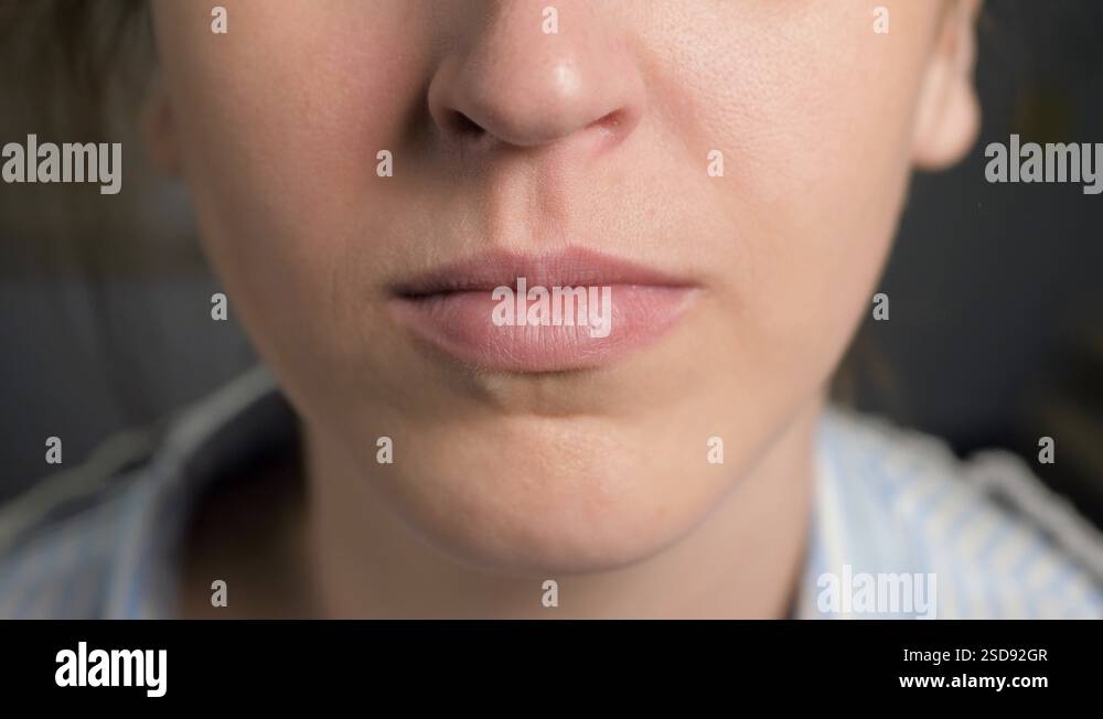 Woman wipes her nose with paper towel. Runny nose, colds, flu ...