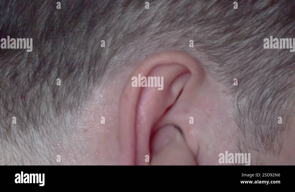 A man scratches his ear with finger Stock Video Footage - Alamy