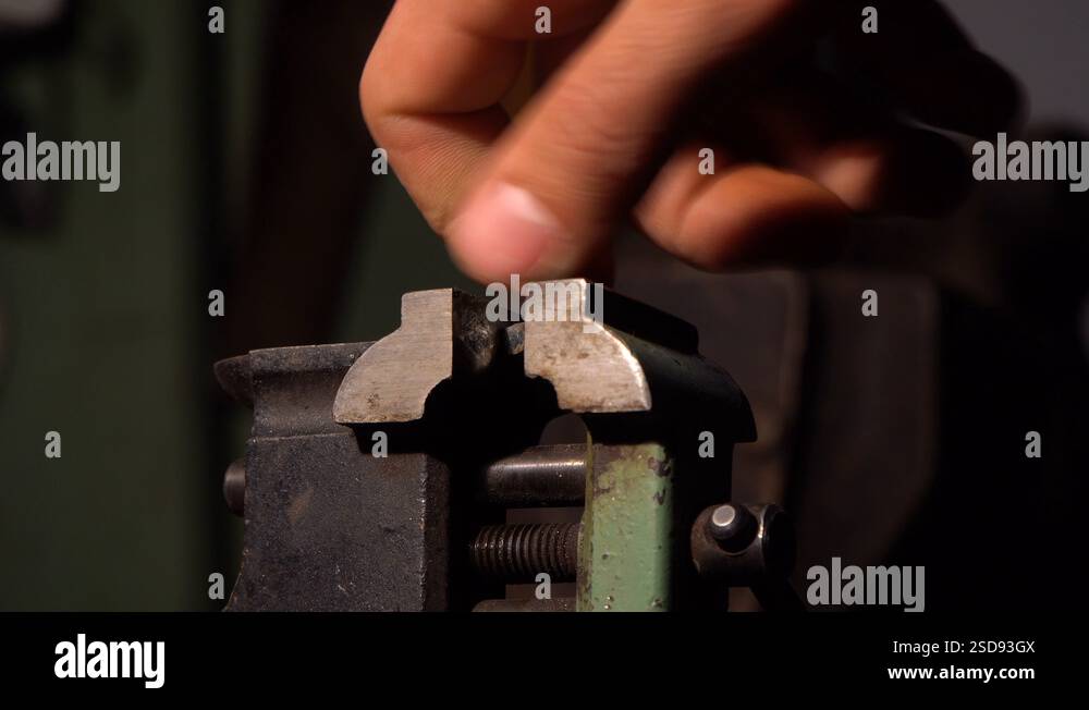 The bolt is fixed in an engineering vice,the arm tightens the nut on ...