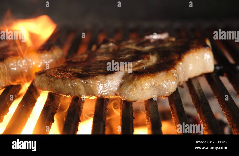 Slide motion shot of cooking barbecue steak meat on grill BBQ Stock ...