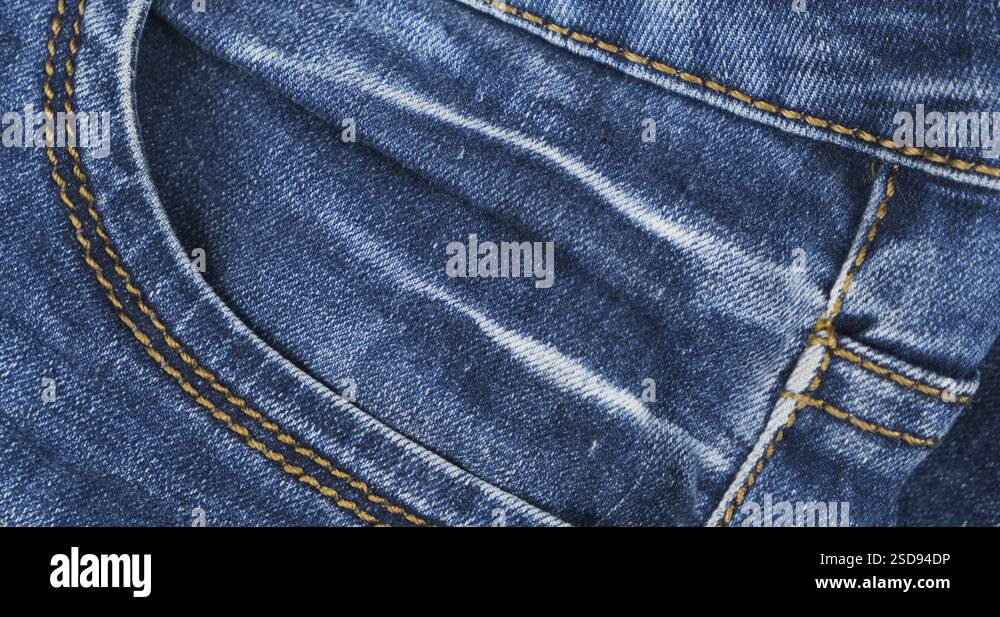 Rotation. Close-up of jeans elements. Jeans pocket and seams close up ...