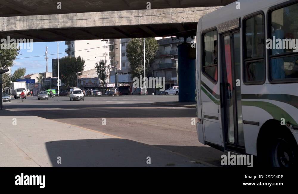 Daily traffic and people walking on Avenida Mitre next to Sarandí train ...