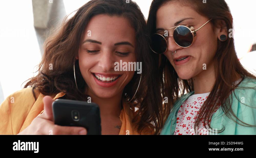 Two girls looking at cellphone, women sharing screen Stock Video ...