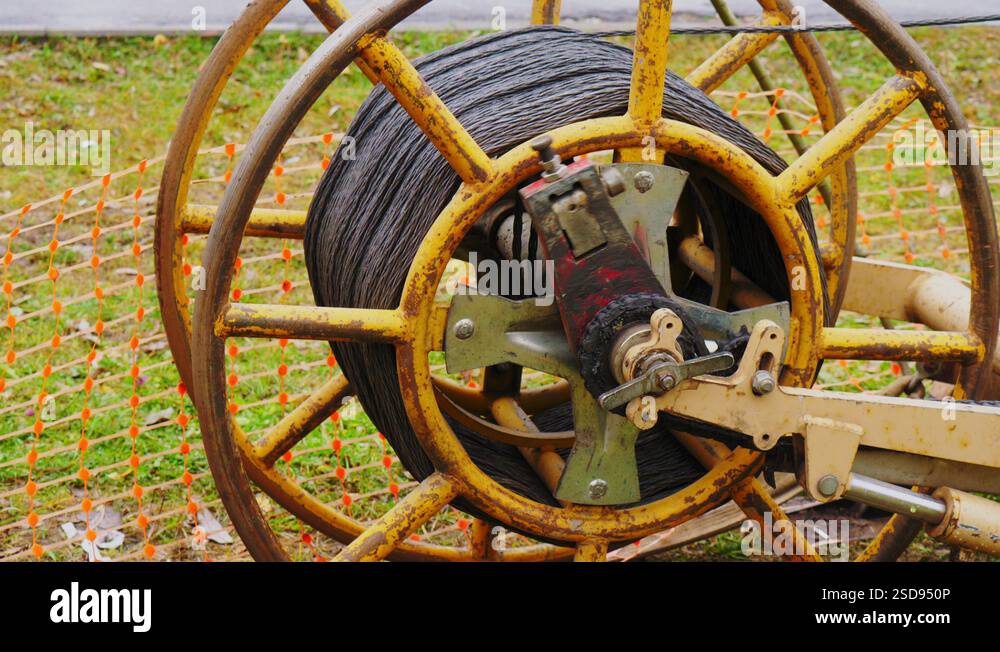 old yellow bobbin with wire and turning chain on green grass Stock ...