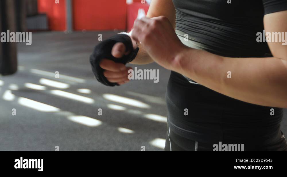 Man boxer unwrapping hands after fighting or training in gym, closeup ...