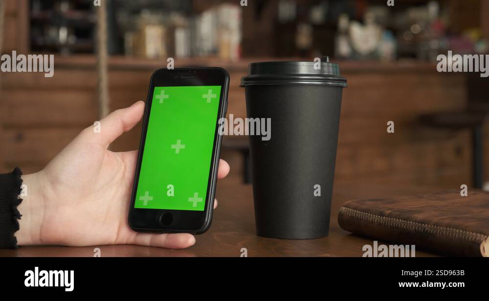 Phone closeup green screen swipe. chroma key mobile bar coffee shop ...