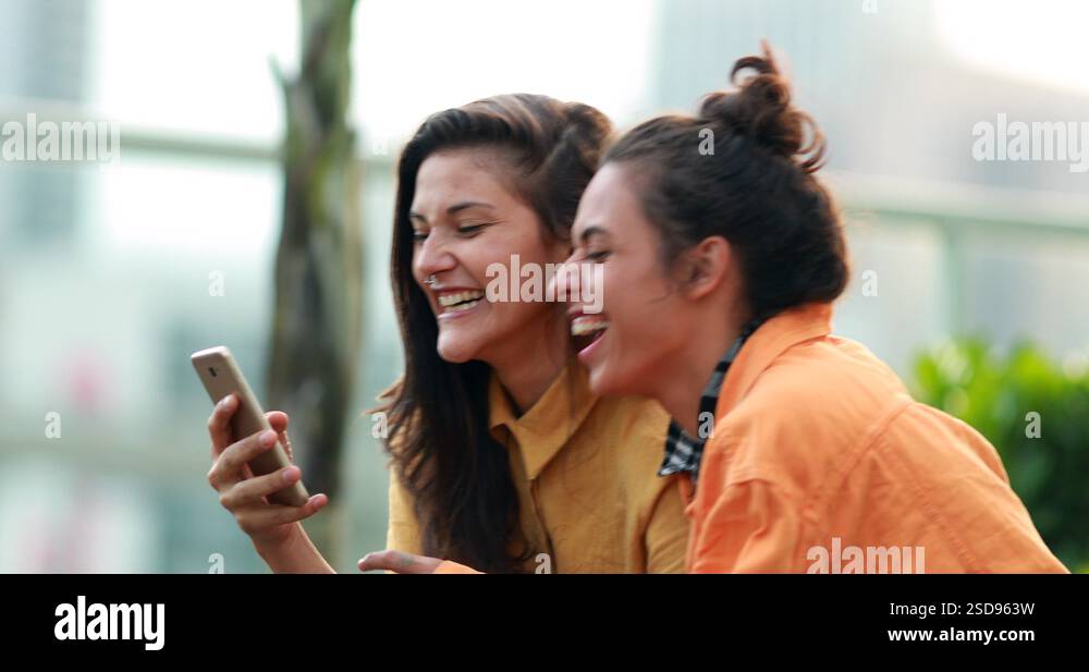 Women reaction laughing out loud. Two young women laughing together to ...