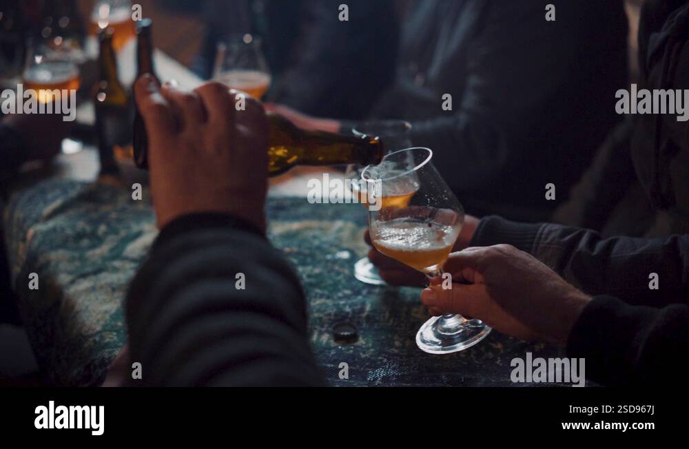 Guy poring a glass of beer in slowmotion in dark setting Stock Video ...