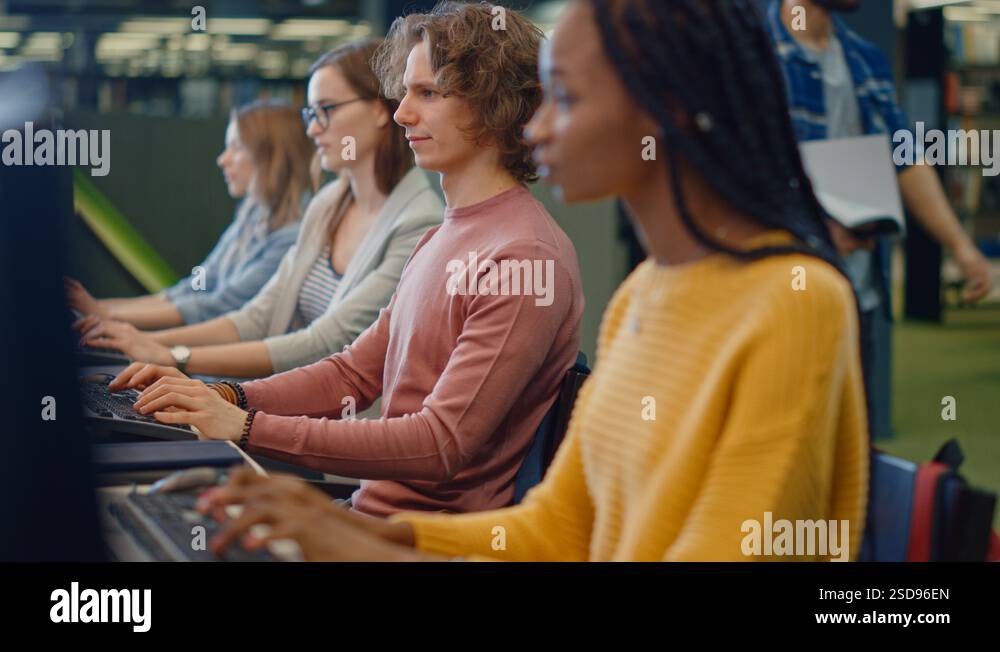 Row of Diverse Group of Multi-Ethnic People Works on Personal Computers ...