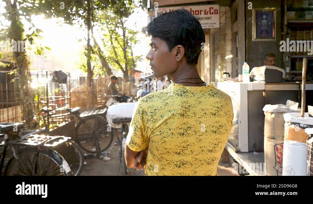 Indian boy standing back to the camera in the middle of the path, Mumbai, India Stock Video ...