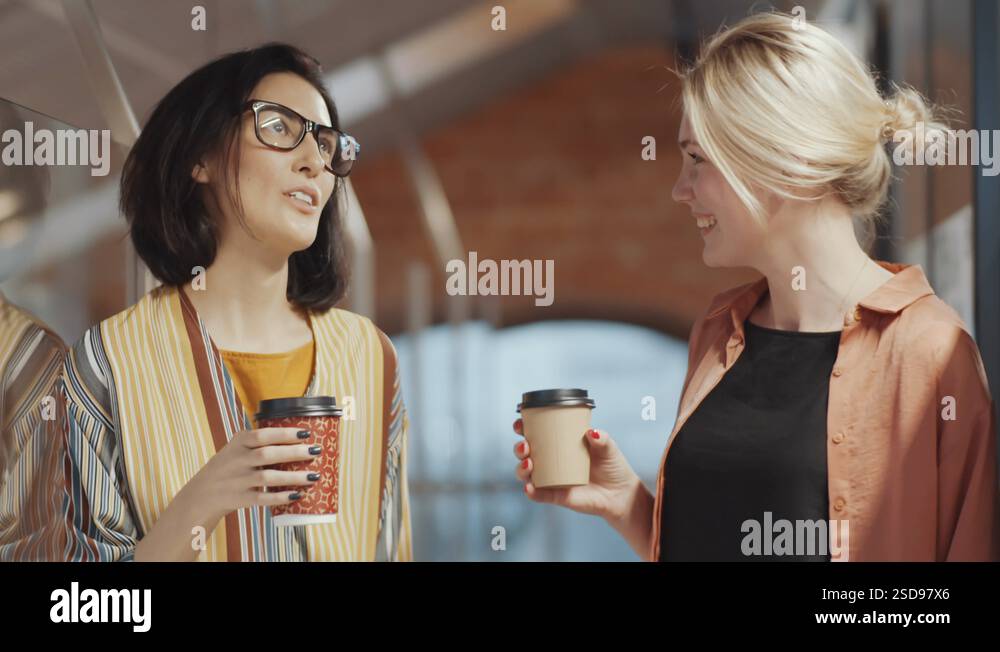 Two Female Coworkers Chatting during Coffee Break in Office Stock Video ...