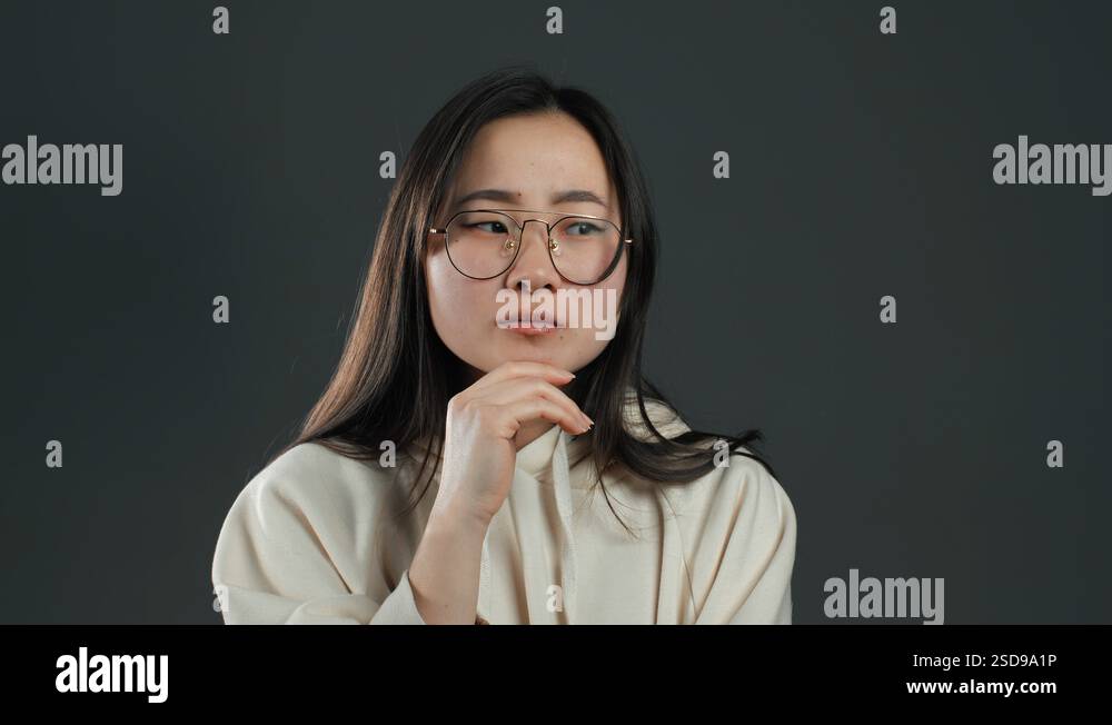 Portrait of asian thinking pondering girl having idea moment pointing ...