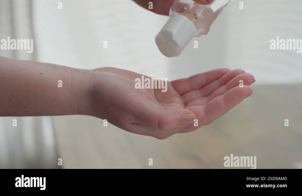 Closeup Of Woman's Hands As She Uses Hand Sanitizer To Clean Her Hands ...