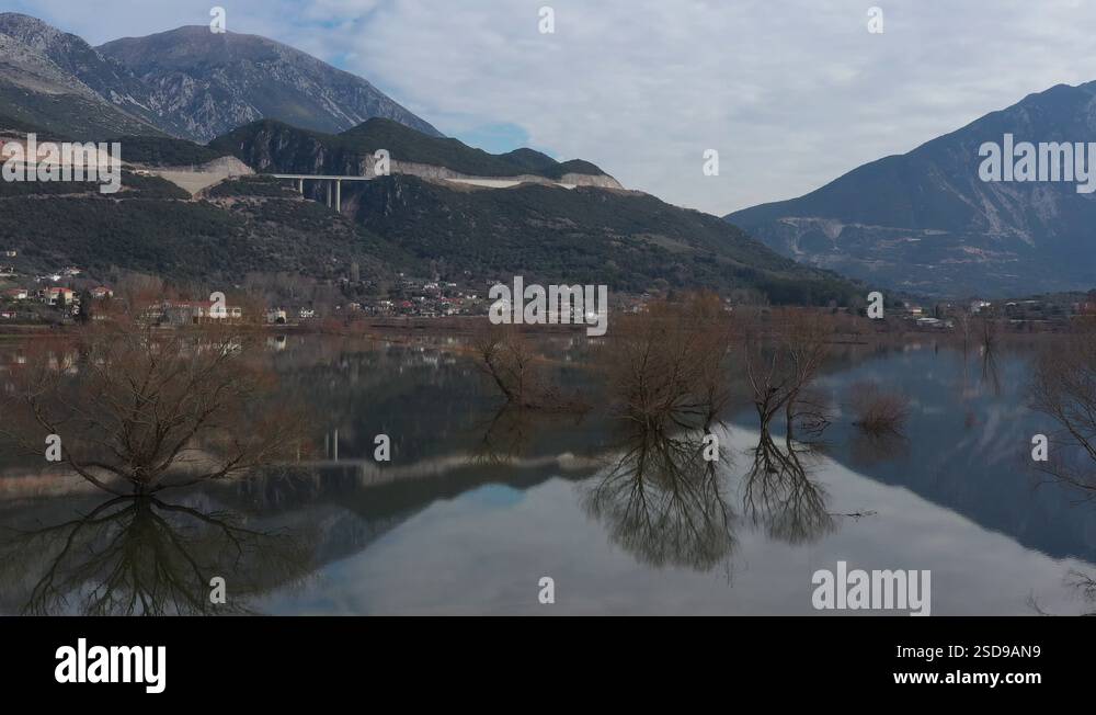 Flight over the flooded valley in Greece. The flooded fields, roads ...