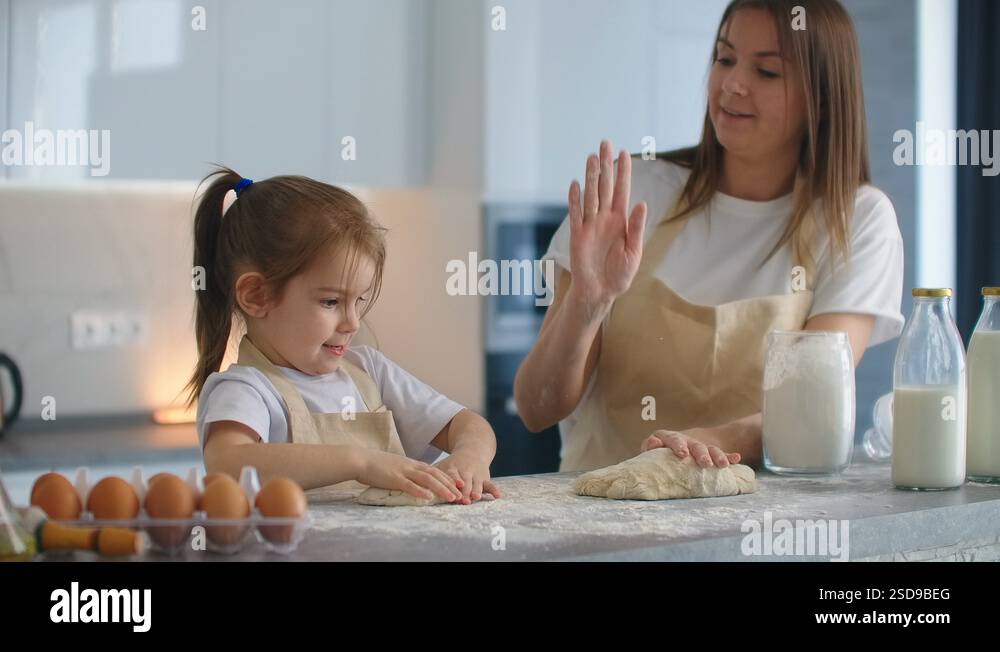 Mom and daughter finished cooking in the kitchen and give five onions ...