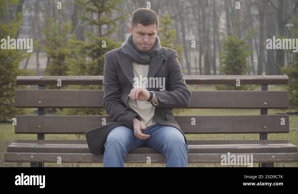 Impatient Caucasian young man checking time on watch and leaving ...