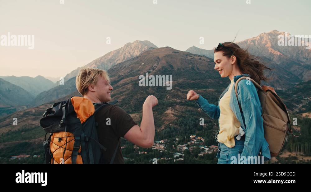 Young couple having an adventure, exploring beautiful mountains, hiking ...