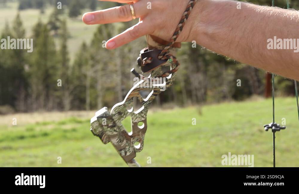 Close up of the hand and arrow rest of a man shooting an arrow from a ...