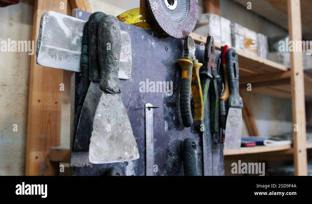 Concrete workshop - many tools on the wall in a concrete workshop Stock ...