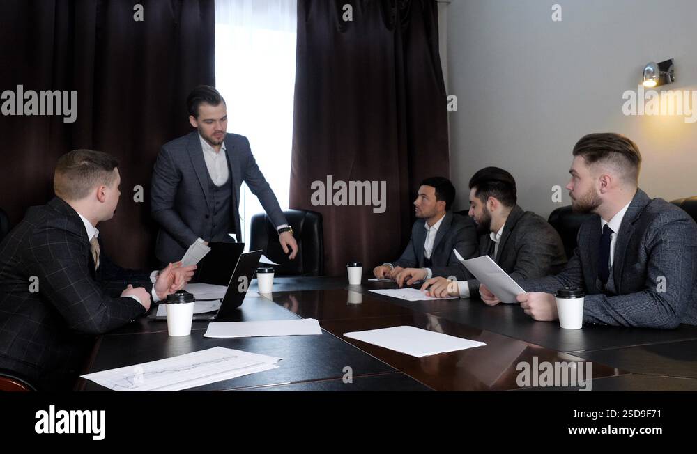 Smiling executive delivers report at business meeting in board room to fun staff Stock Video ...