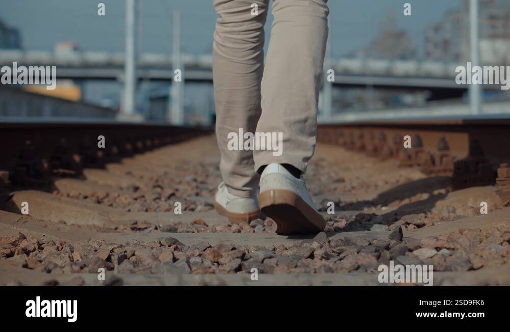 Man Walks Railroad Tracks Or Rails. Legs Walking On Railway Rail Line ...