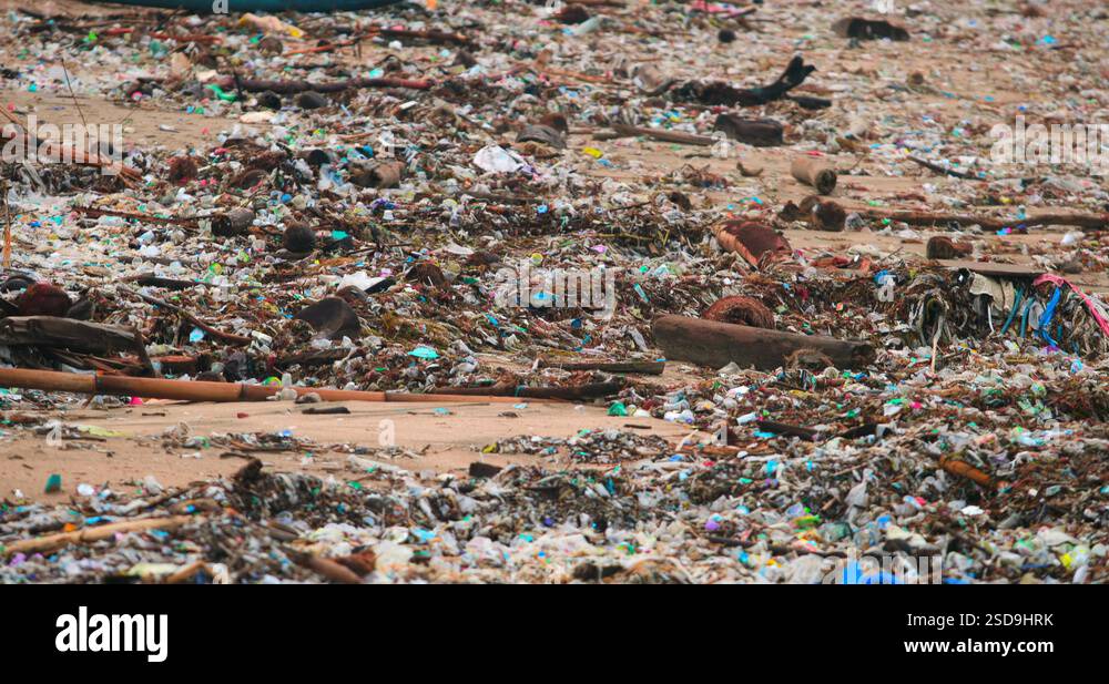 Sea waves full of litter hitting the beach. Huge dump in tropical ...