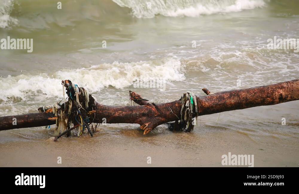 Sea waves full of litter hitting the beach. Huge dump in tropical ...