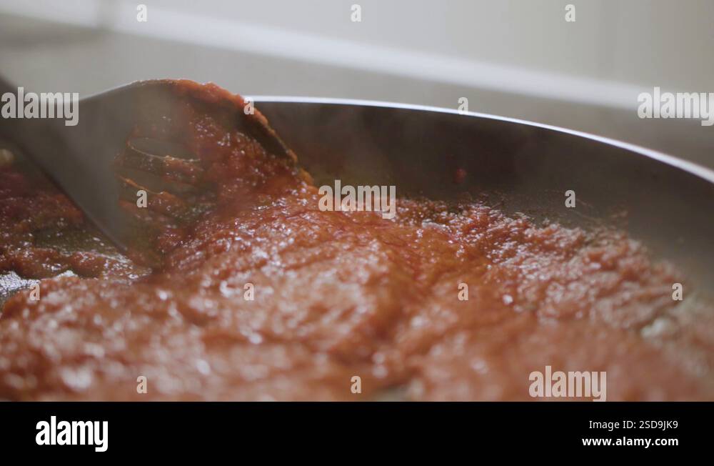 Mixing sauce in a frying pan (SLOW MOTION) | Extreme close-up Stock ...